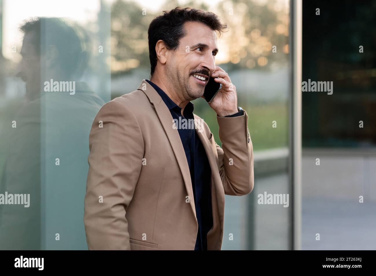 Businessman Engaging in Important Phone Call Downtown Stock Photo - Alamy