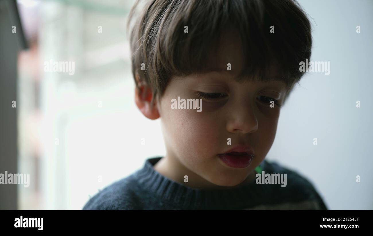 Pensive small boy close-up face. Child drooling in deep contemplative ...