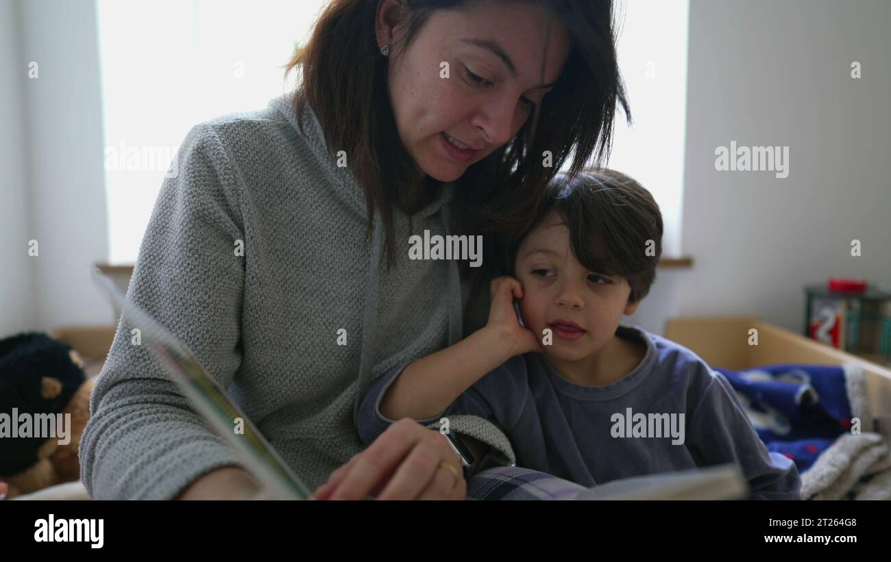 Mother Reading Book to Little Boy Sitting at Bedside, Child Absorbed by ...