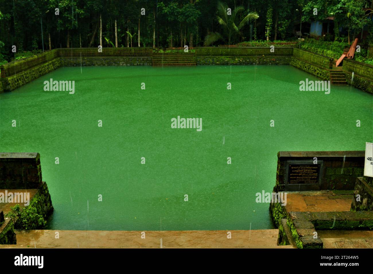 Beautiful and huge temple pond during monsoon Stock Photo - Alamy
