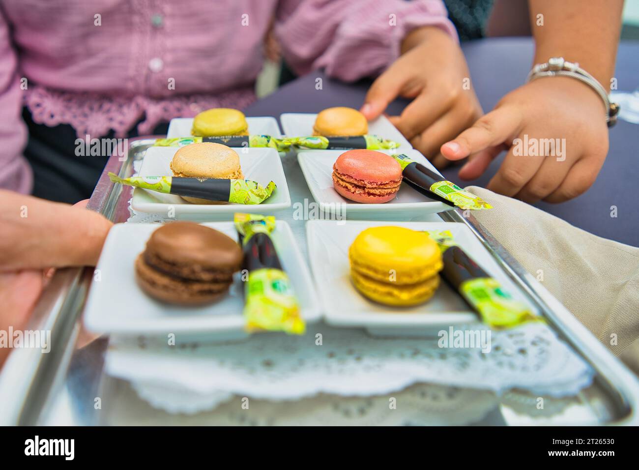 child pointing finger on her favourite macaron selections on the ...