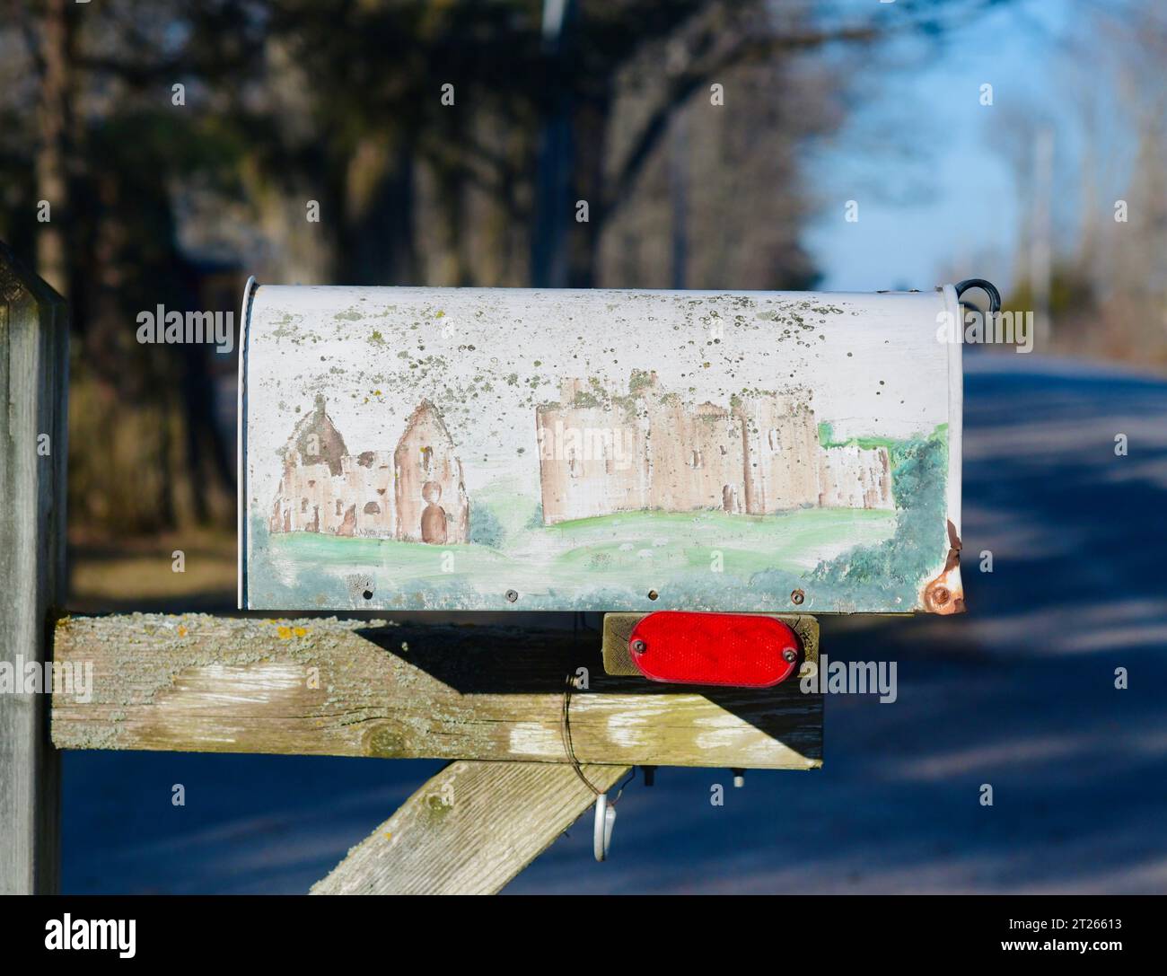 An antique wooden rural mailbox with a hand-painted watercolor ...