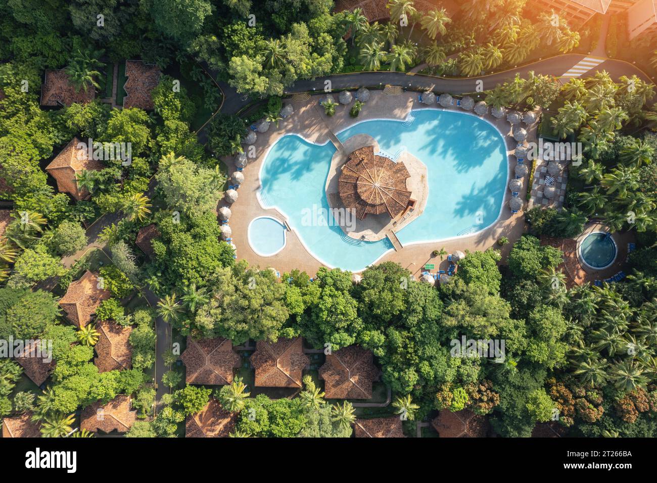 Clean blue pool in tropical resort above top drone view in bright sunny ...