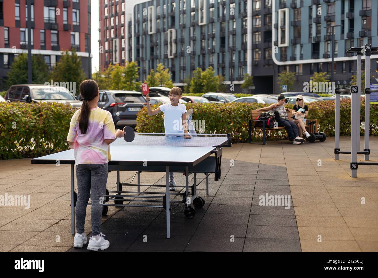 Kid playing table tennis outdoor with family Stock Photo - Alamy