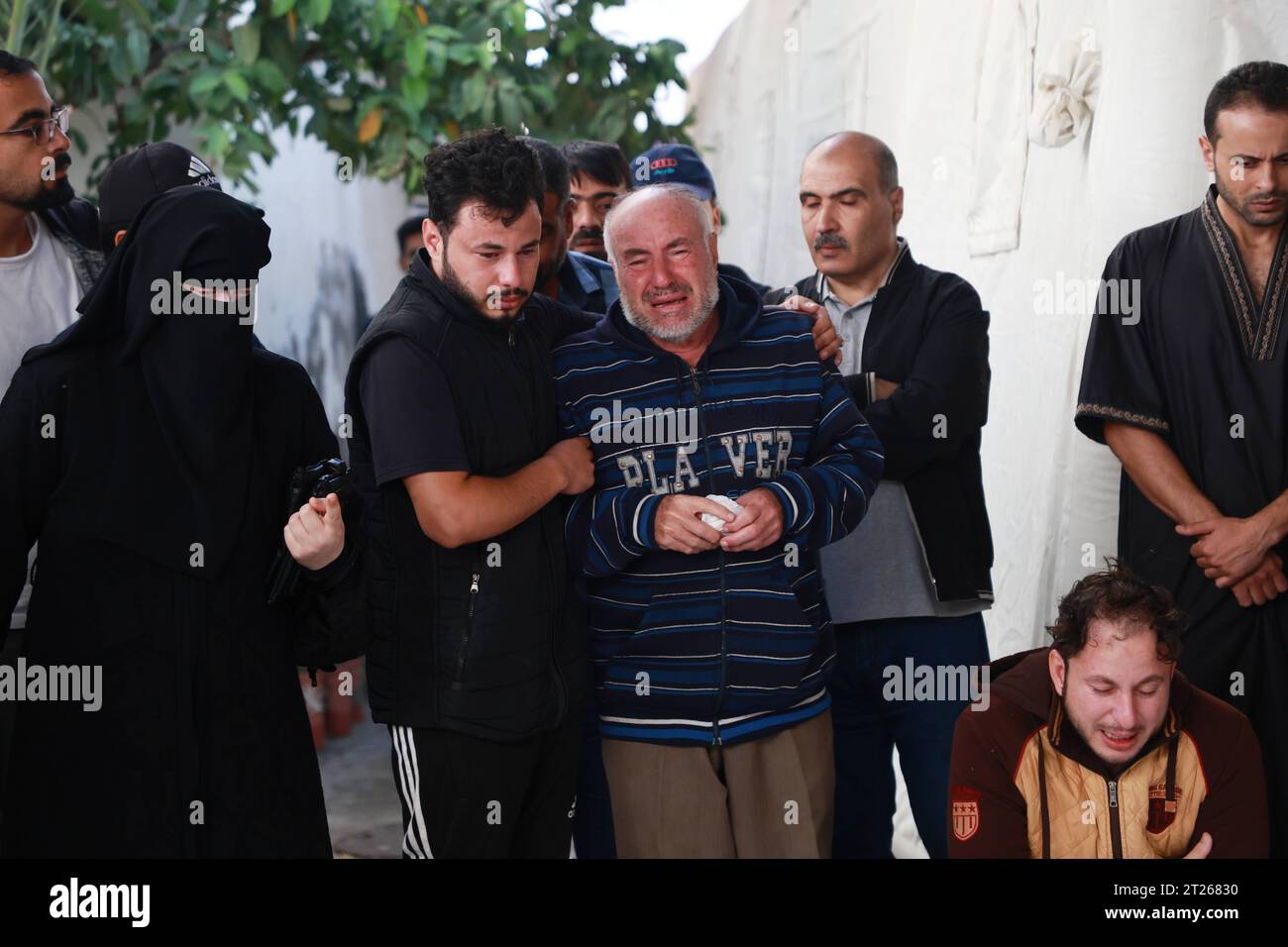 Palestinians evacuate victims following an Israeli airstrike on ...