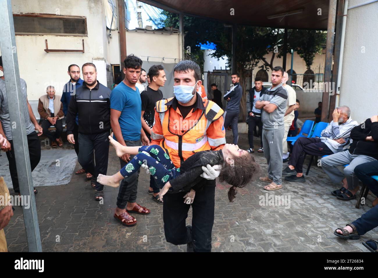 Palestinians evacuate victims following an Israeli airstrike on ...