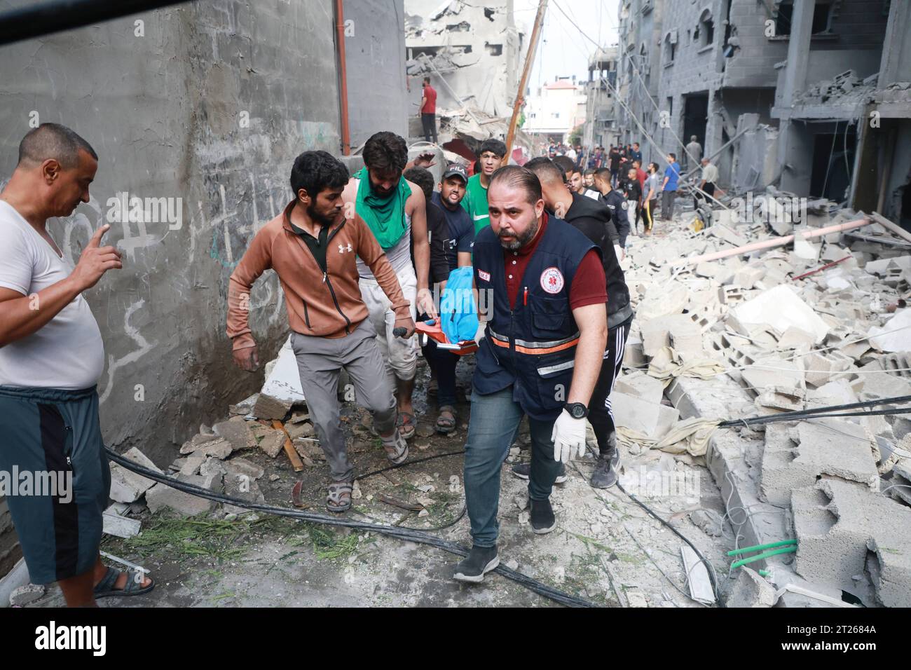 Palestinians evacuate victims following an Israeli airstrike on ...