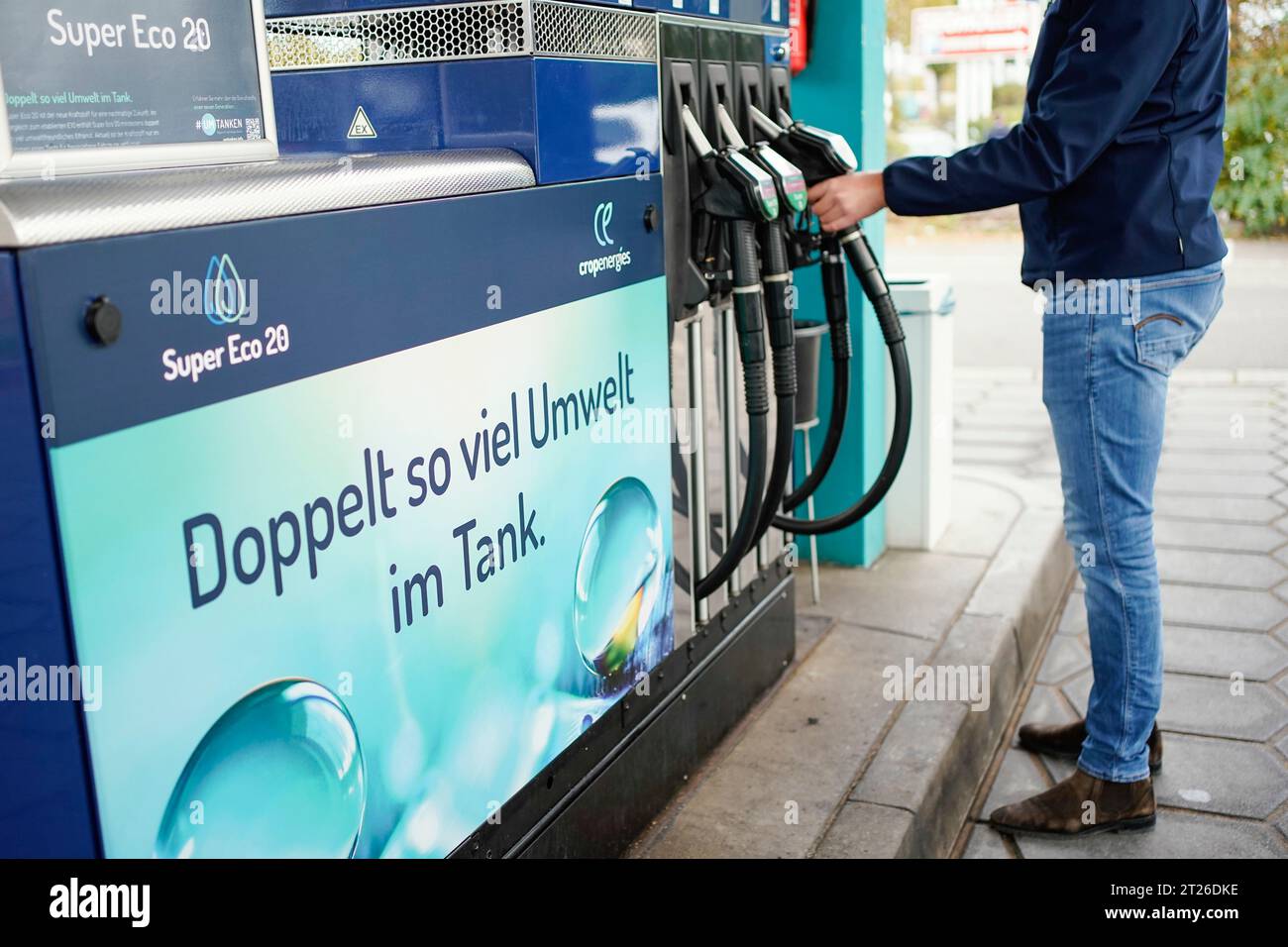 Mannheim, Germany. 17th Oct, 2023. A man stands in front of a gas pump ...