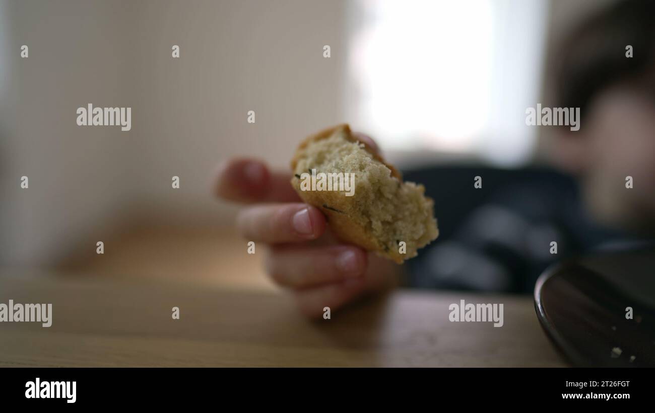 Close-up of child hand holding piece of bread, kid feeding carb food ...
