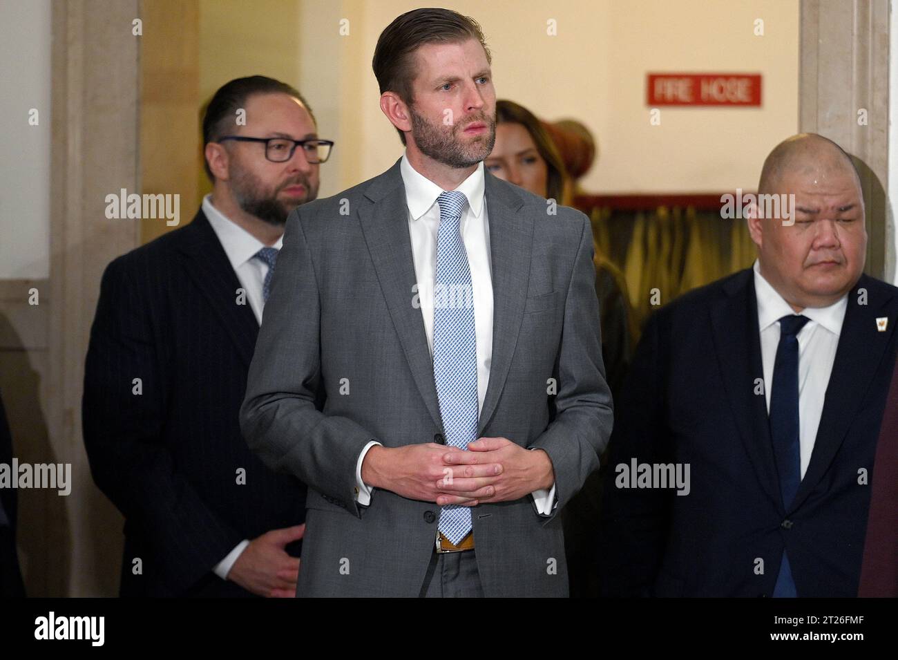 New York, USA. 17th Oct, 2023. Eric Trump listens to former U.S ...