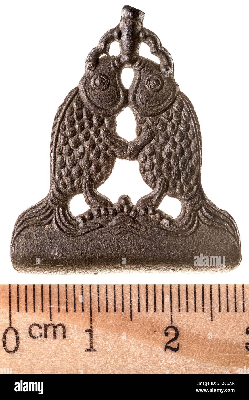 An ancient tin coin of Malaysia in the form of two carp. Obverse ...