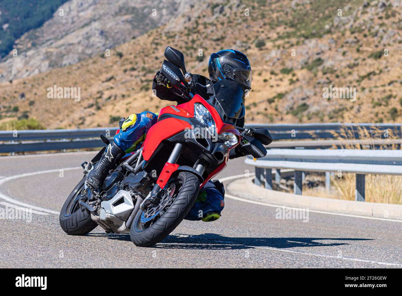 Motorcyclist taking a curve in the port of Navalmoral, province of ...