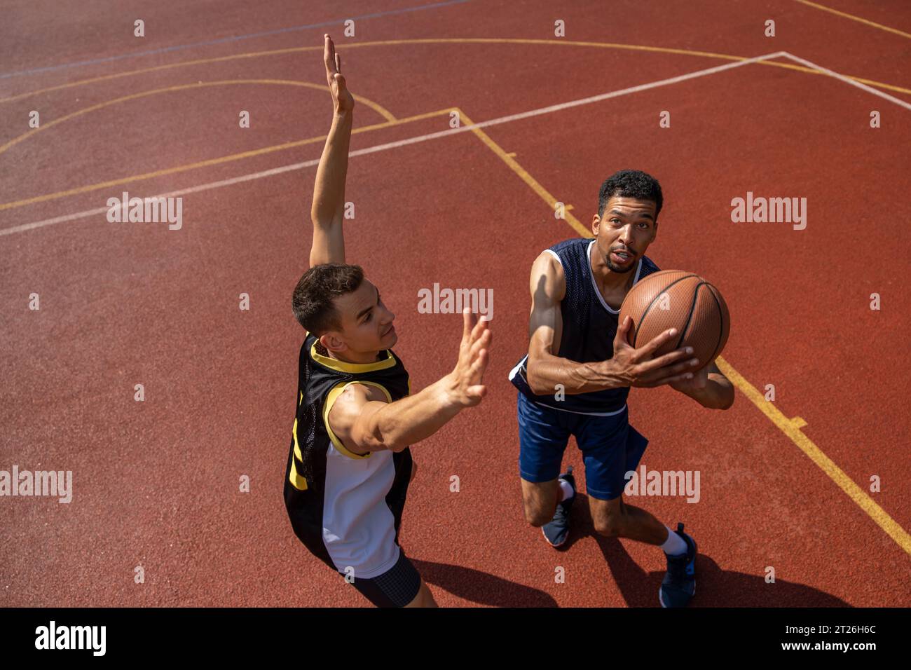 Two young friends playing basketball hi-res stock photography and ...