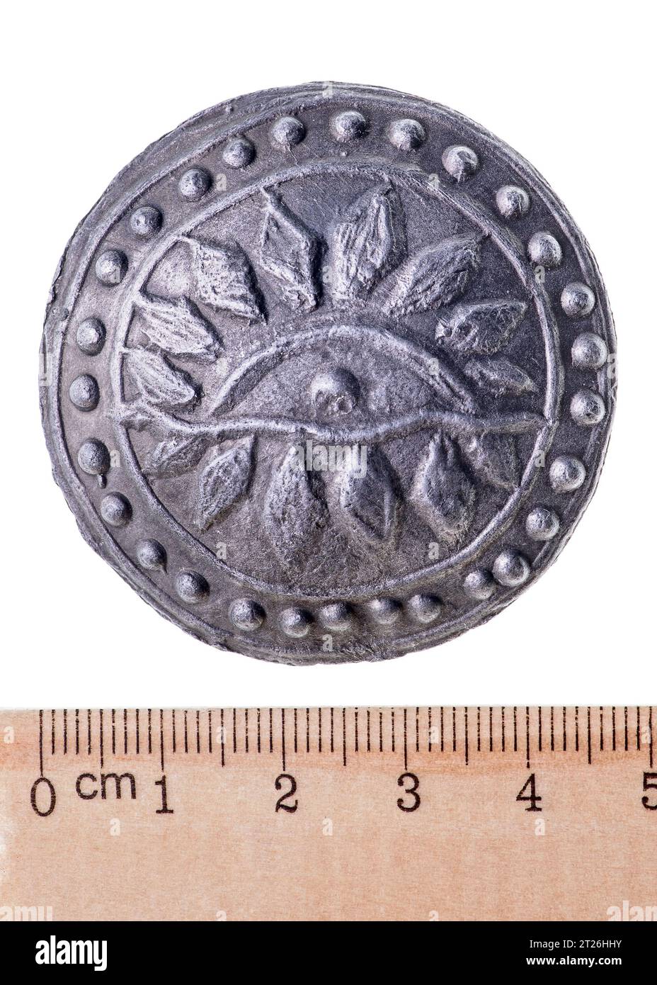 An ancient tin zinc Burmese coin depicting the sunrise. Obverse ...