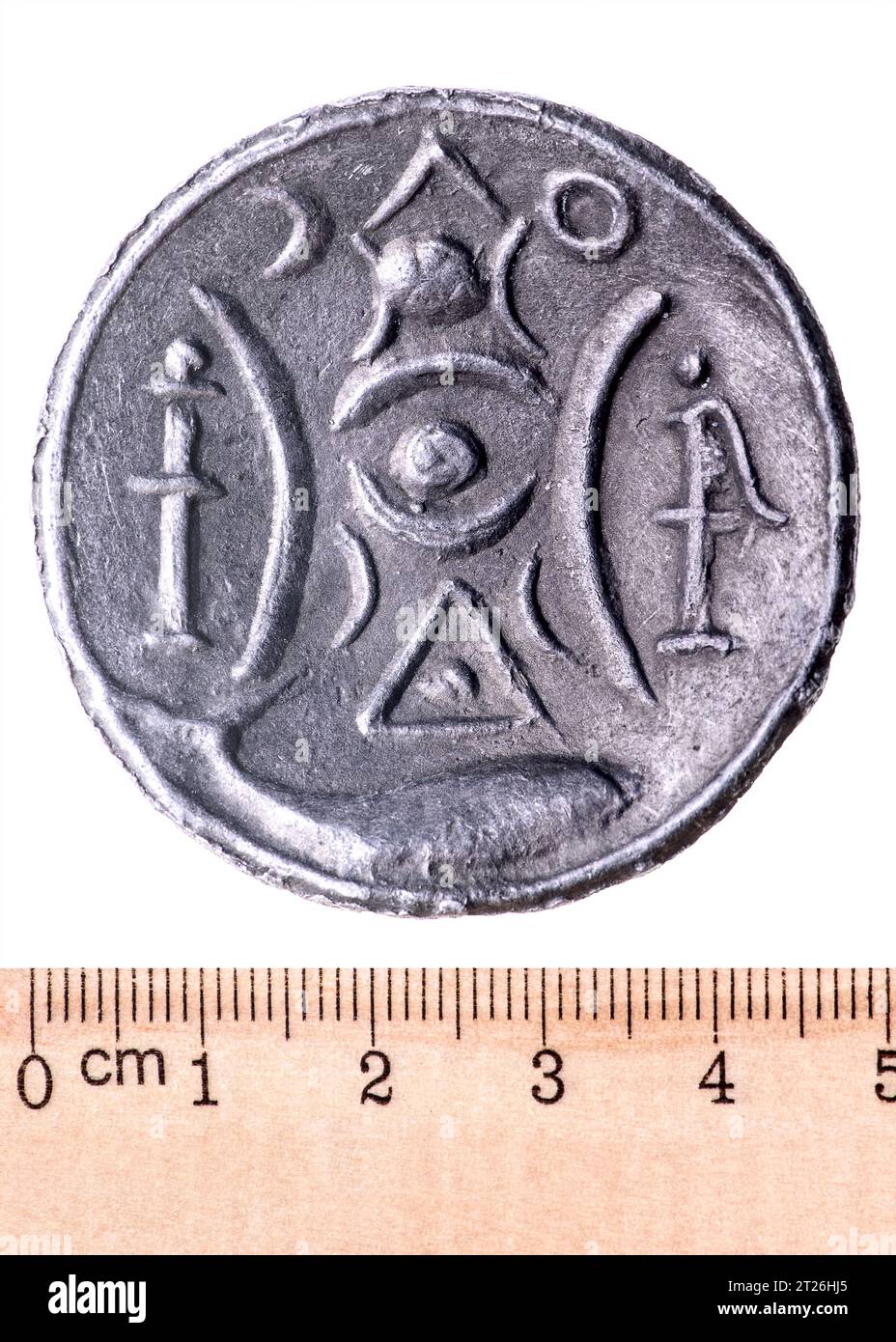 An ancient tin zinc Burmese coin depicting the sunrise. Obverse ...