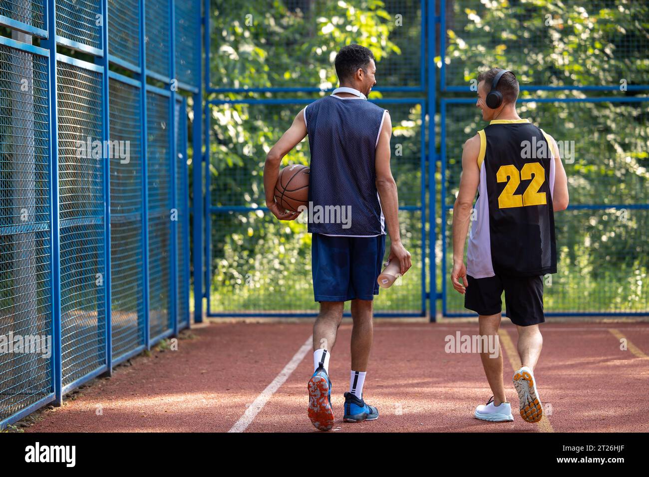 Two men friends players walking on basketball court Stock Photo - Alamy
