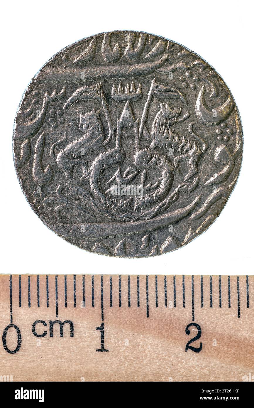 An ancient silver Indian coin is one rupee. United Provinces of Agra ...