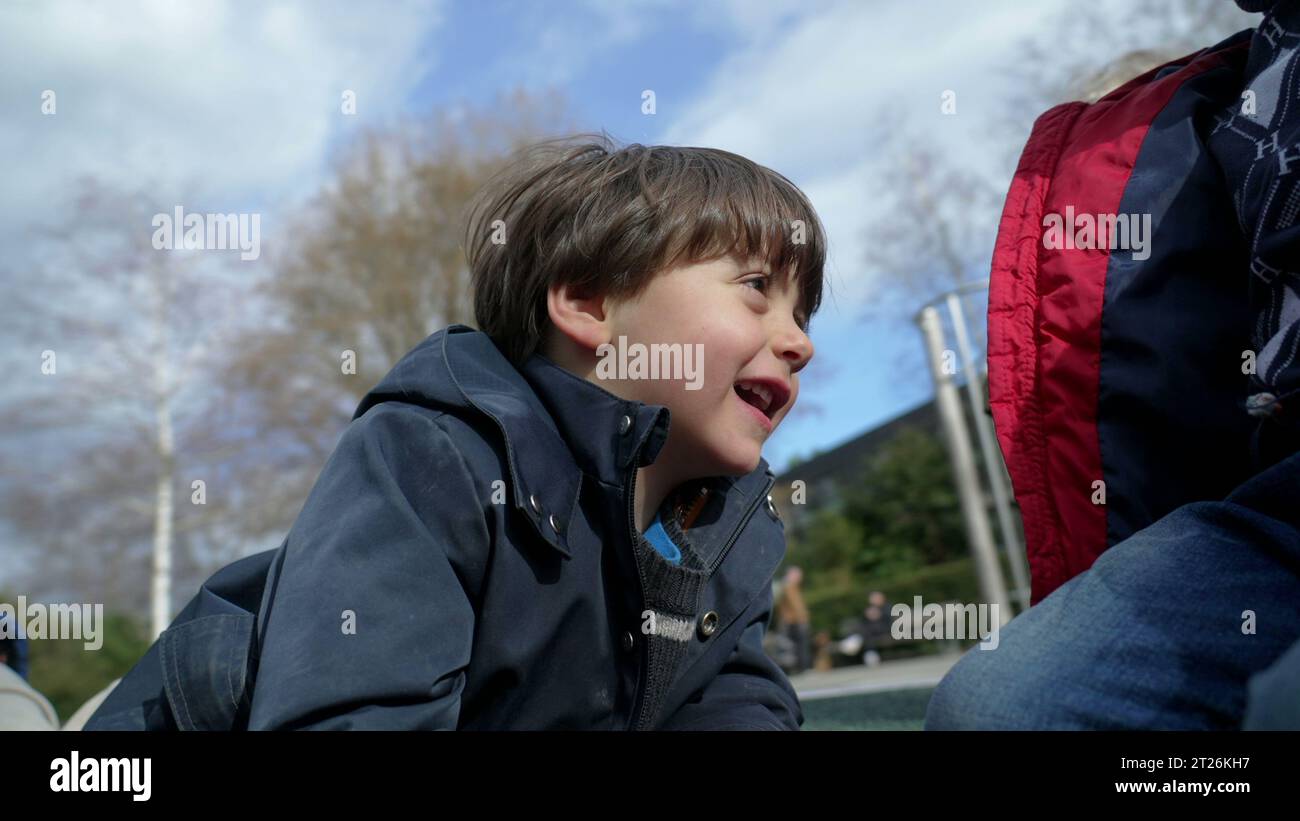 Child having fun at merry-go-round playground park during fall or ...