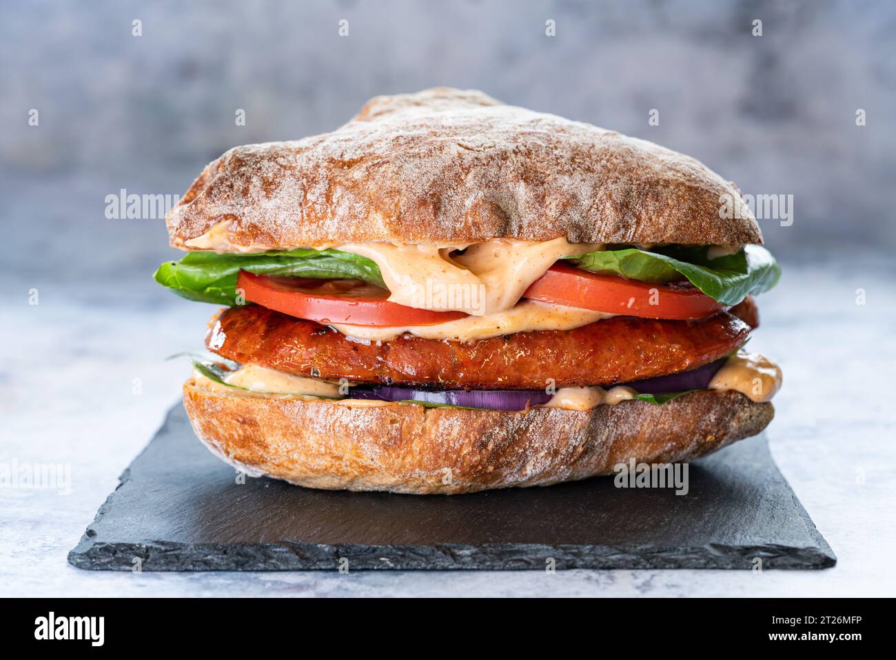 Bread roll with Nduja sausage, fresh tomato, onion, green lettuce, mayo ...