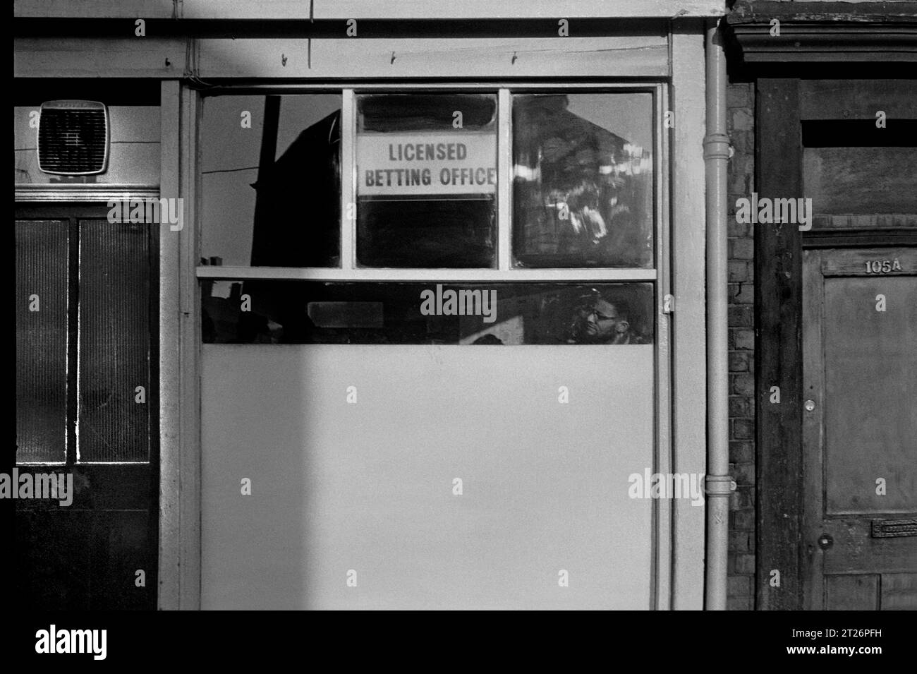 Closed down and boarded up window to a licensed betting office during ...