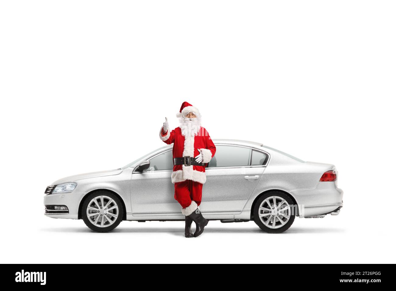 Santa claus leaning on a silver car and gesturing thumbs up isolated on ...