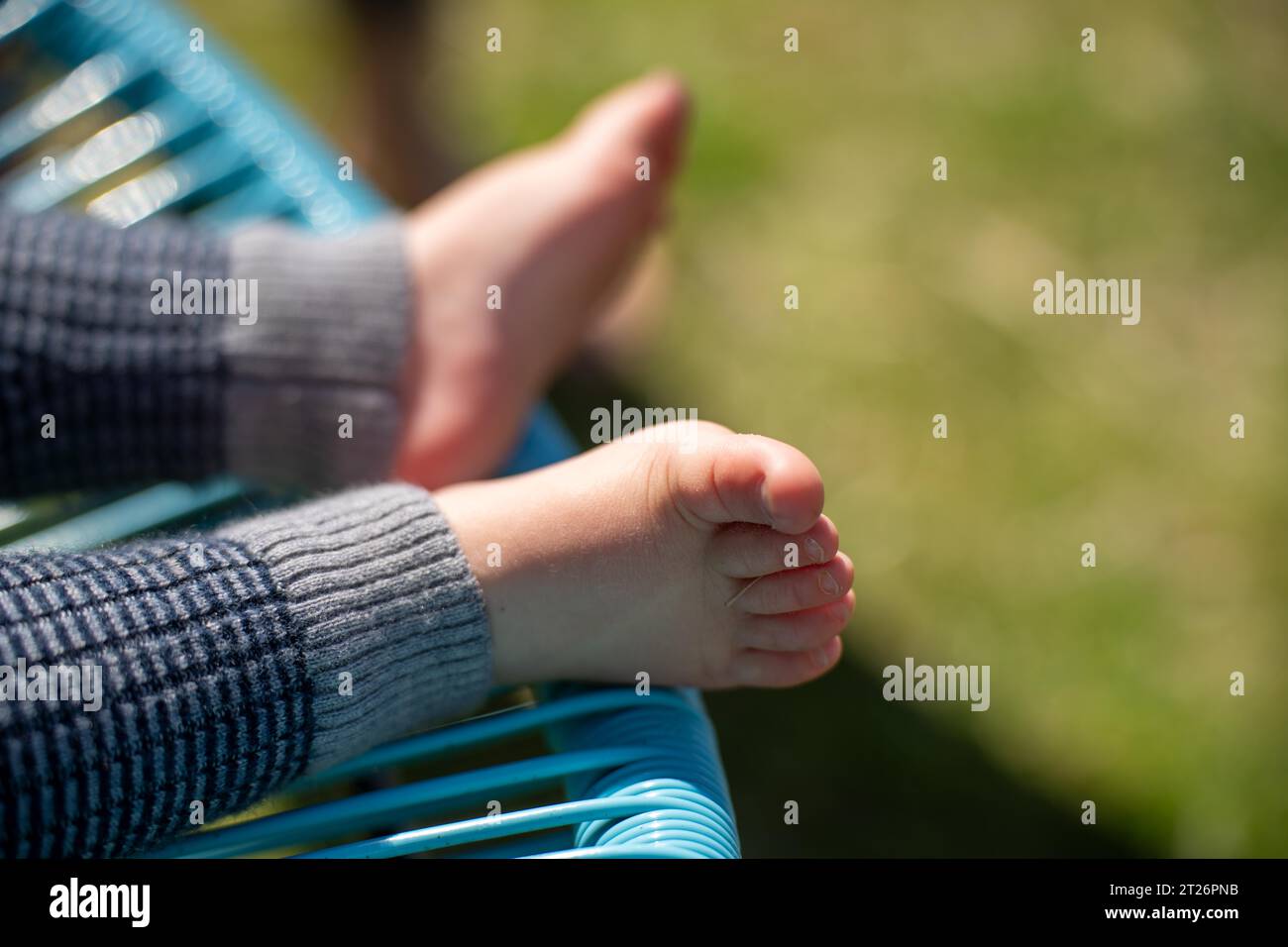 toddler feet in a chair. baby foot close up on grass Stock Photo - Alamy