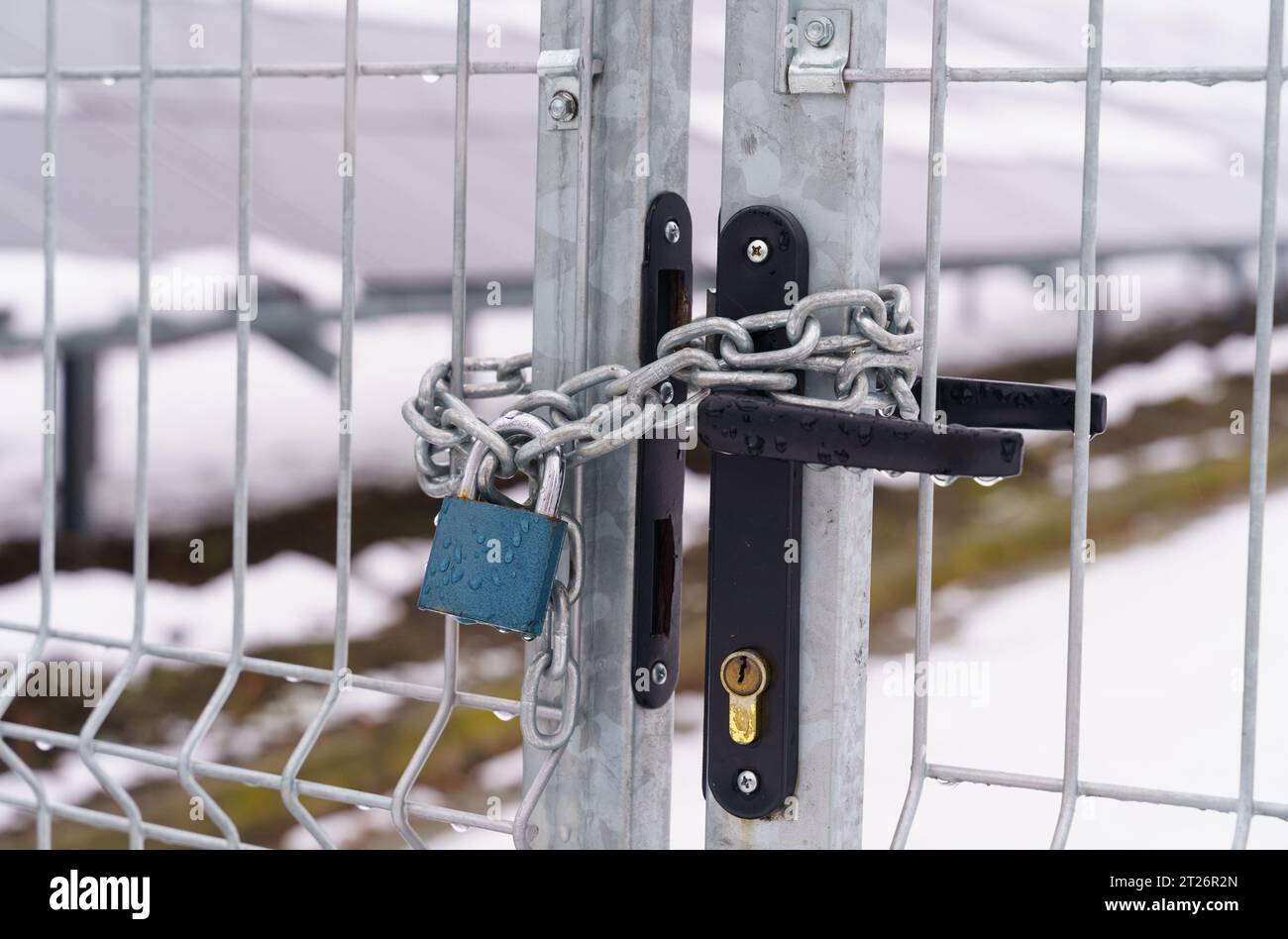 Metal gate closed with a chain to the castle Stock Photo - Alamy