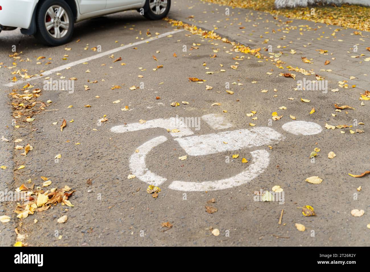 Special parking space for a car driven by a disabled person. Road ...
