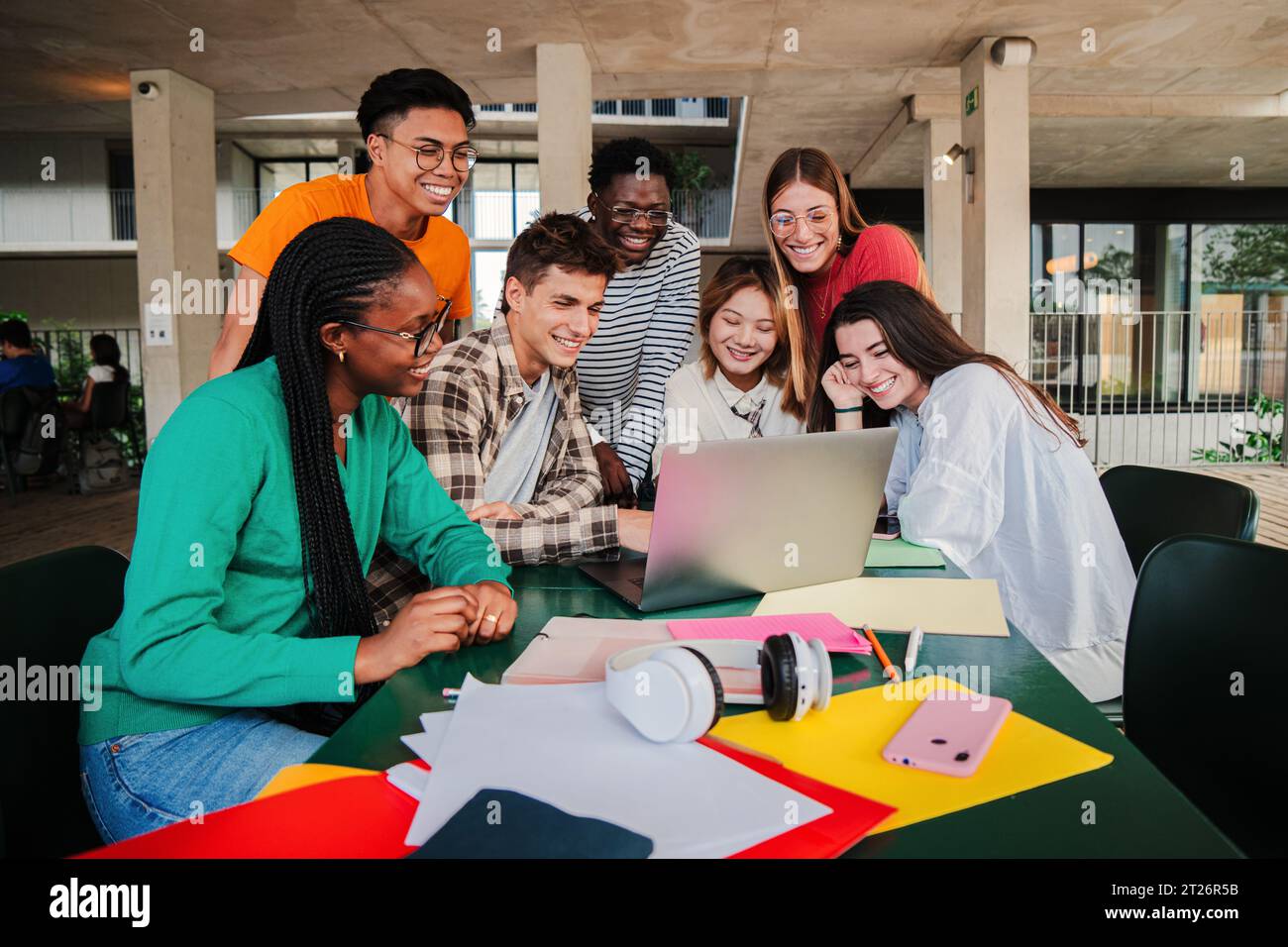 Big group of multiracial teenage students using laptop, working on ...