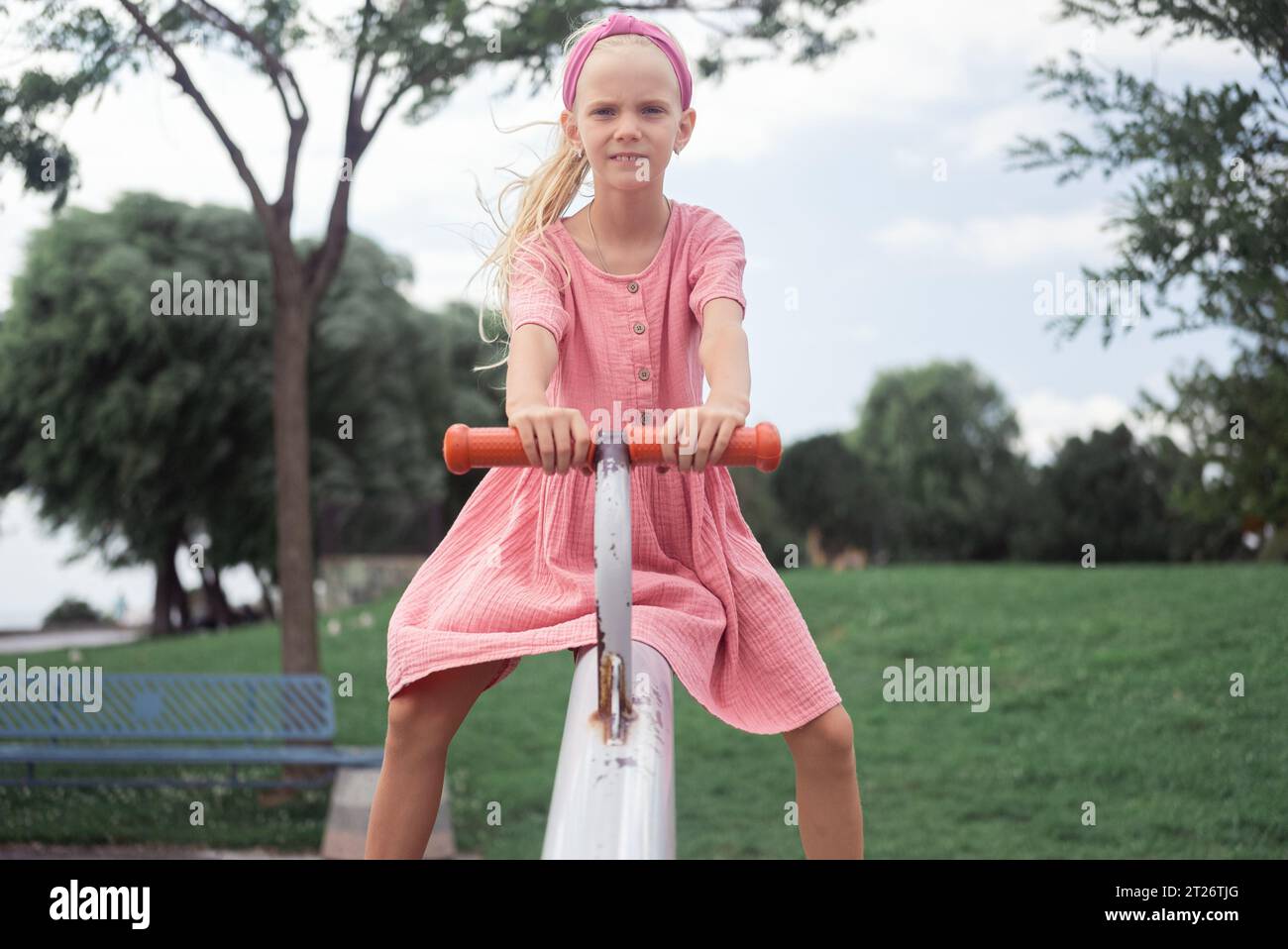 Playful child on seesaw, sharing smiles and laughter in urban park ...