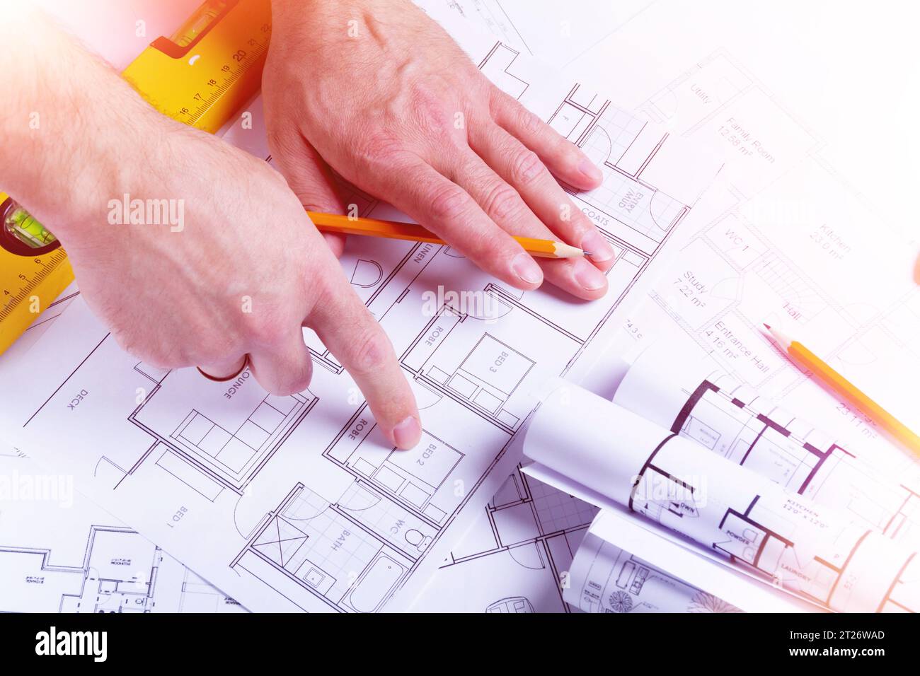 Builder's hands on the background of a house plan. Construction ...