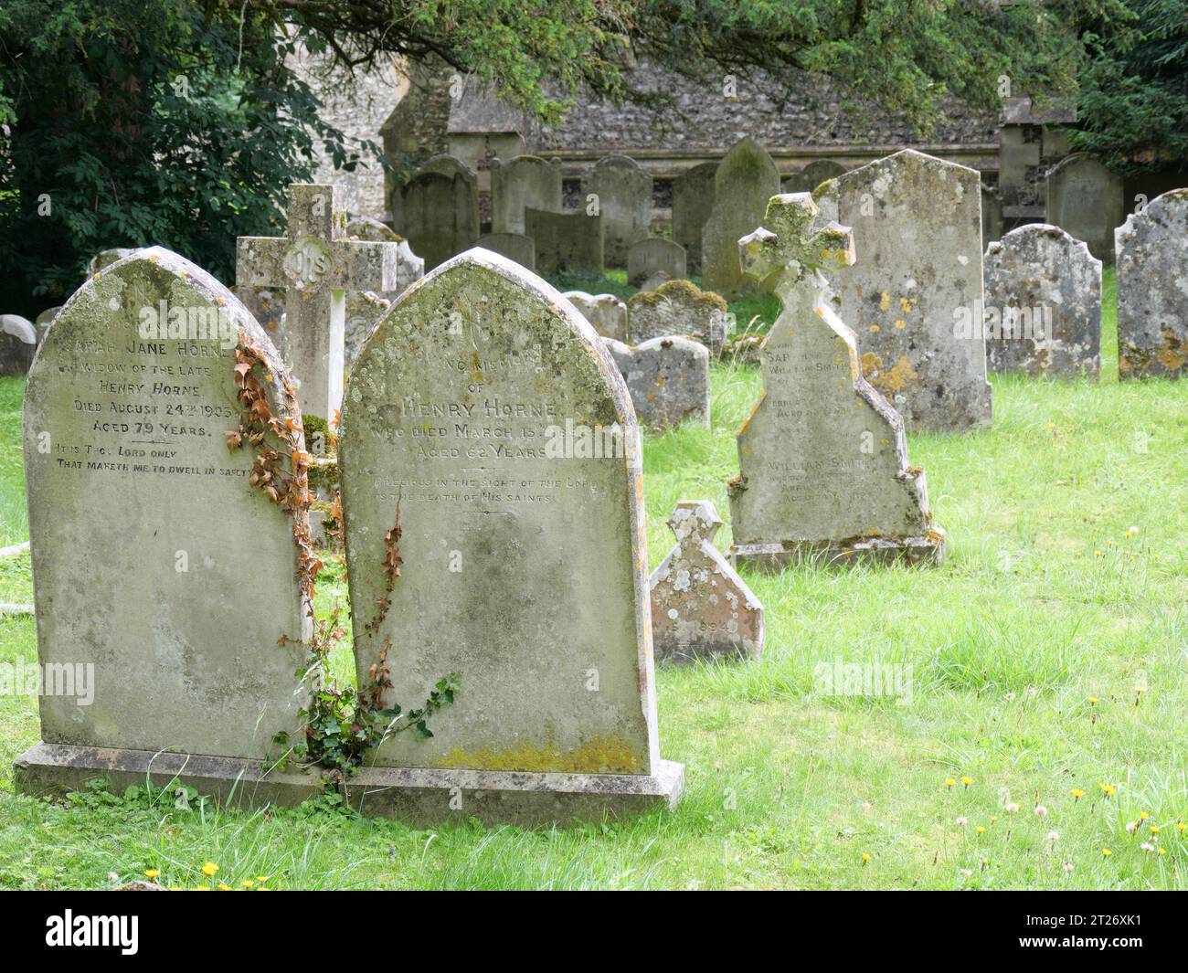 Old gravestone standing in front of a church in Wherwell England Stock ...