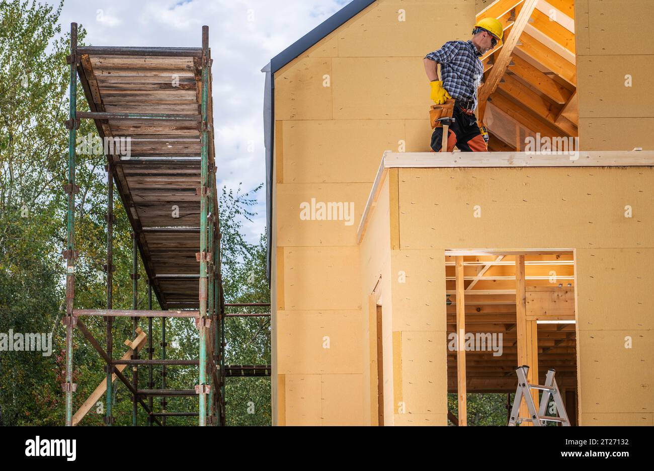 Construction Worker and the Newly Built Small Wooden Residential House ...
