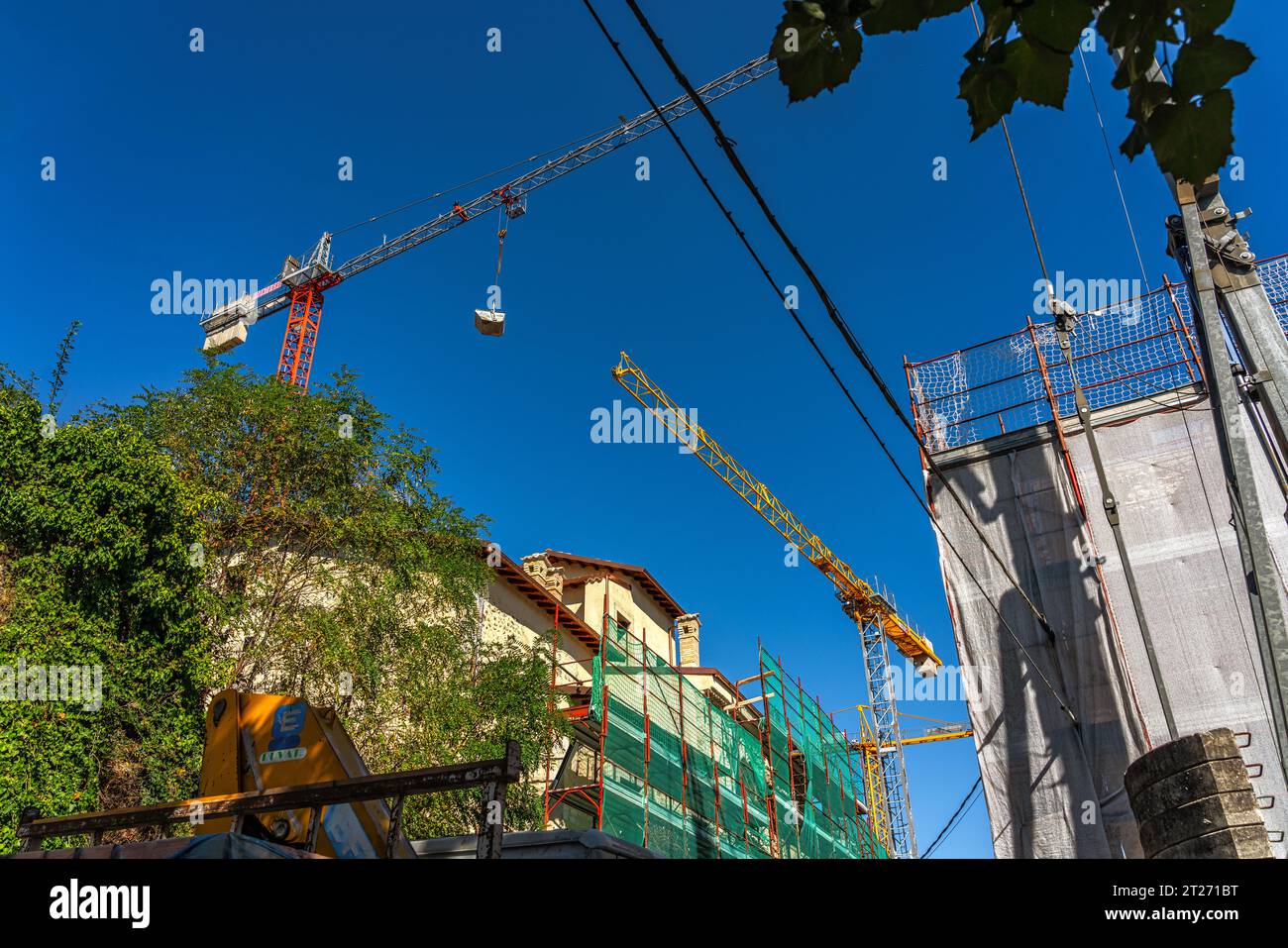 Cranes soar in the sky during the reconstruction of the medieval town ...