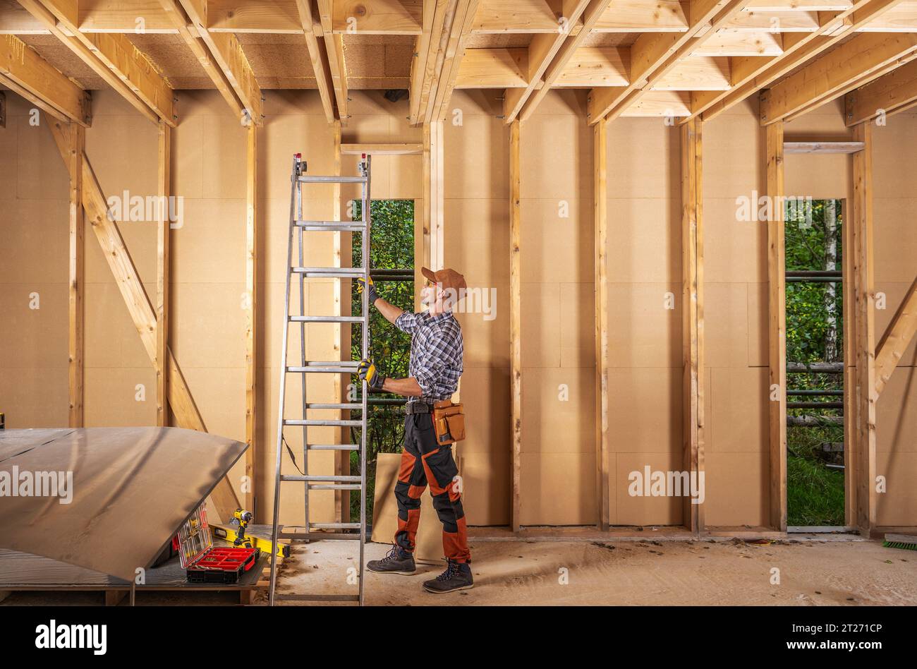 Caucasian Construction Contractor Moving Aluminium Ladder Inside the ...