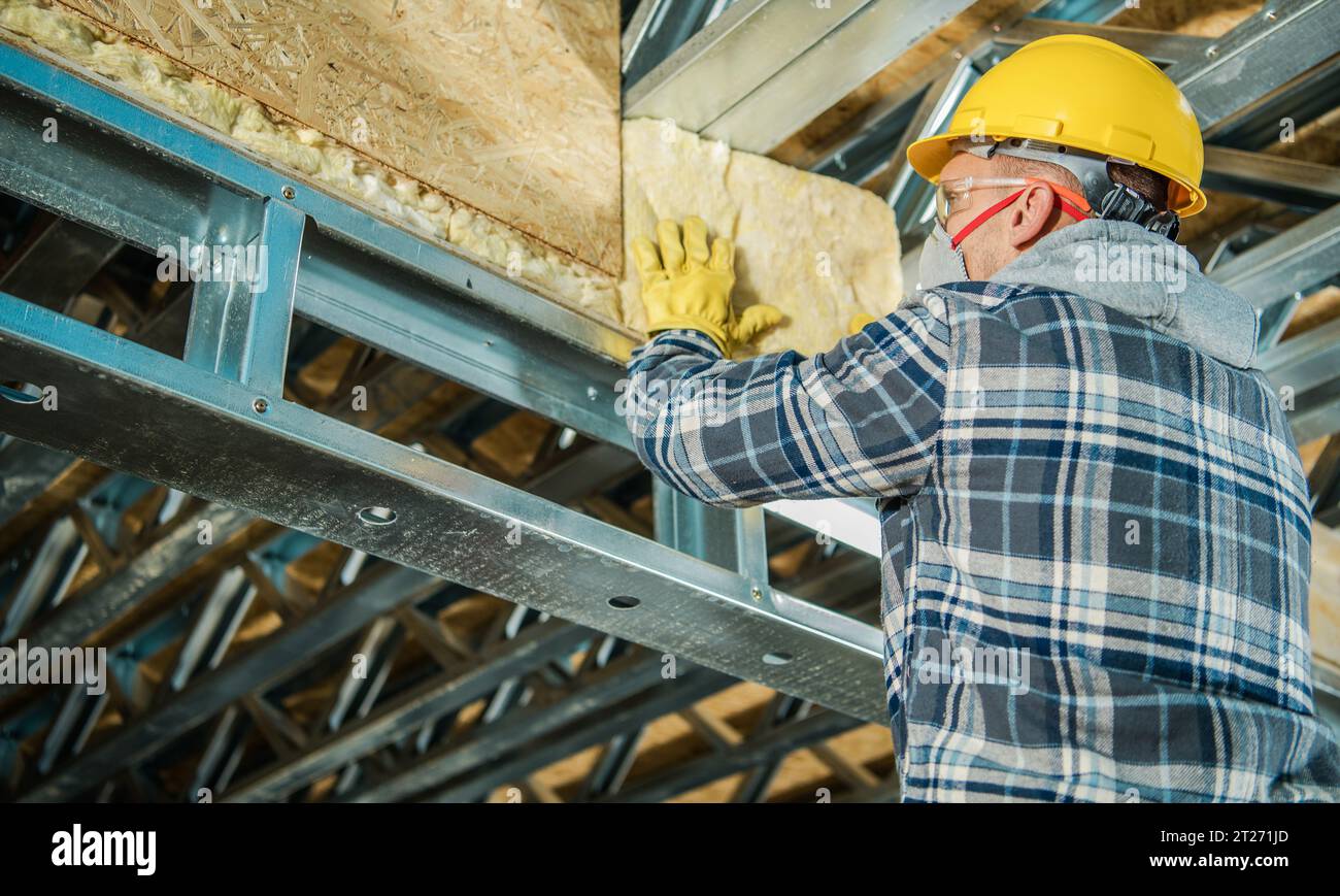 Contractor Worker Installing Mineral Wool Insulation in Newly Built ...
