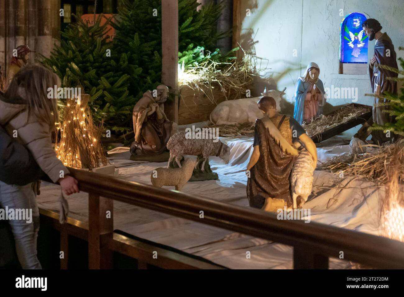 Father and daughter look at the Christmas nativity scene Stock Photo ...
