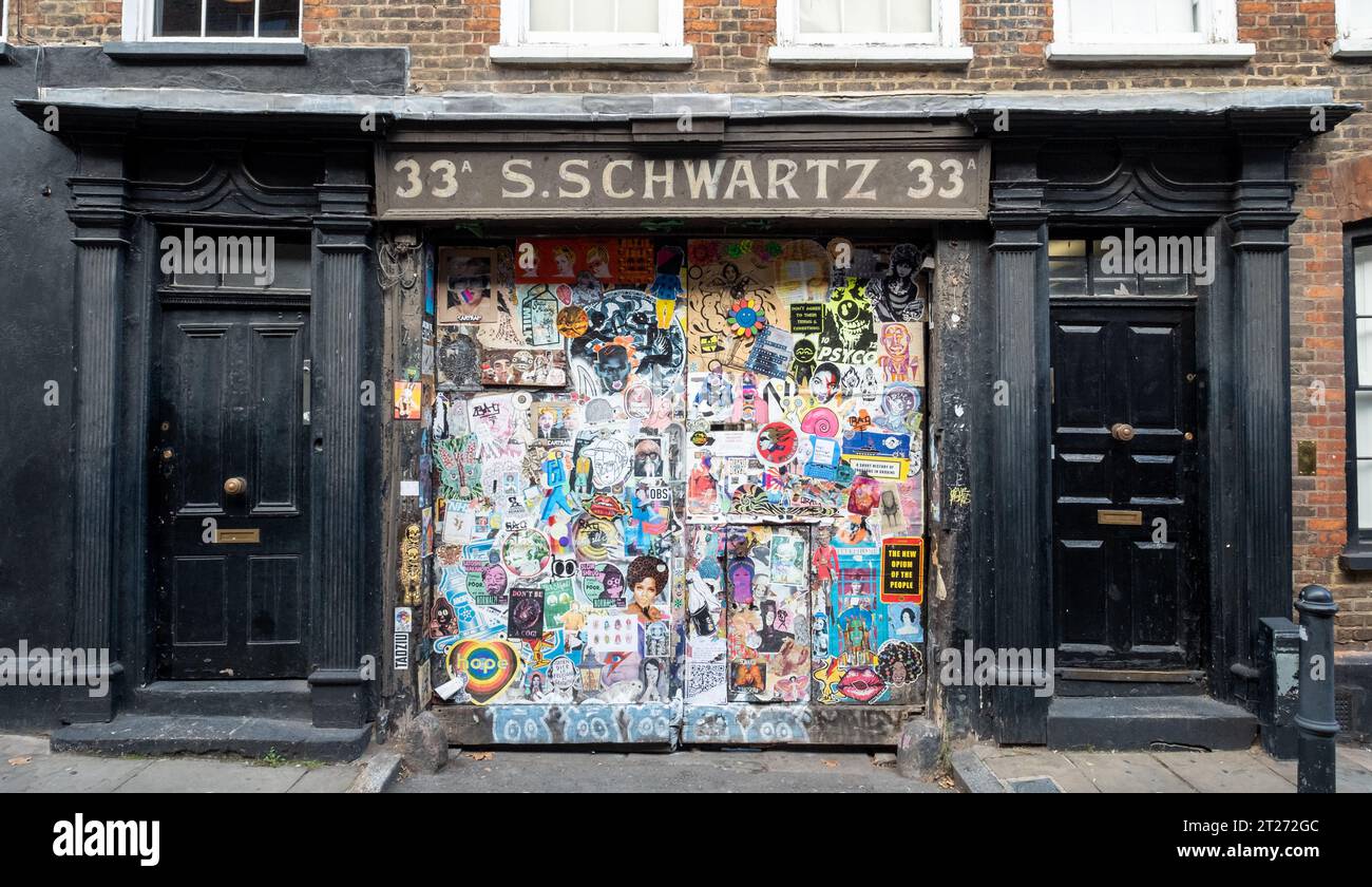 Characterful historic Huguenot houses with black doors and graffiti on ...