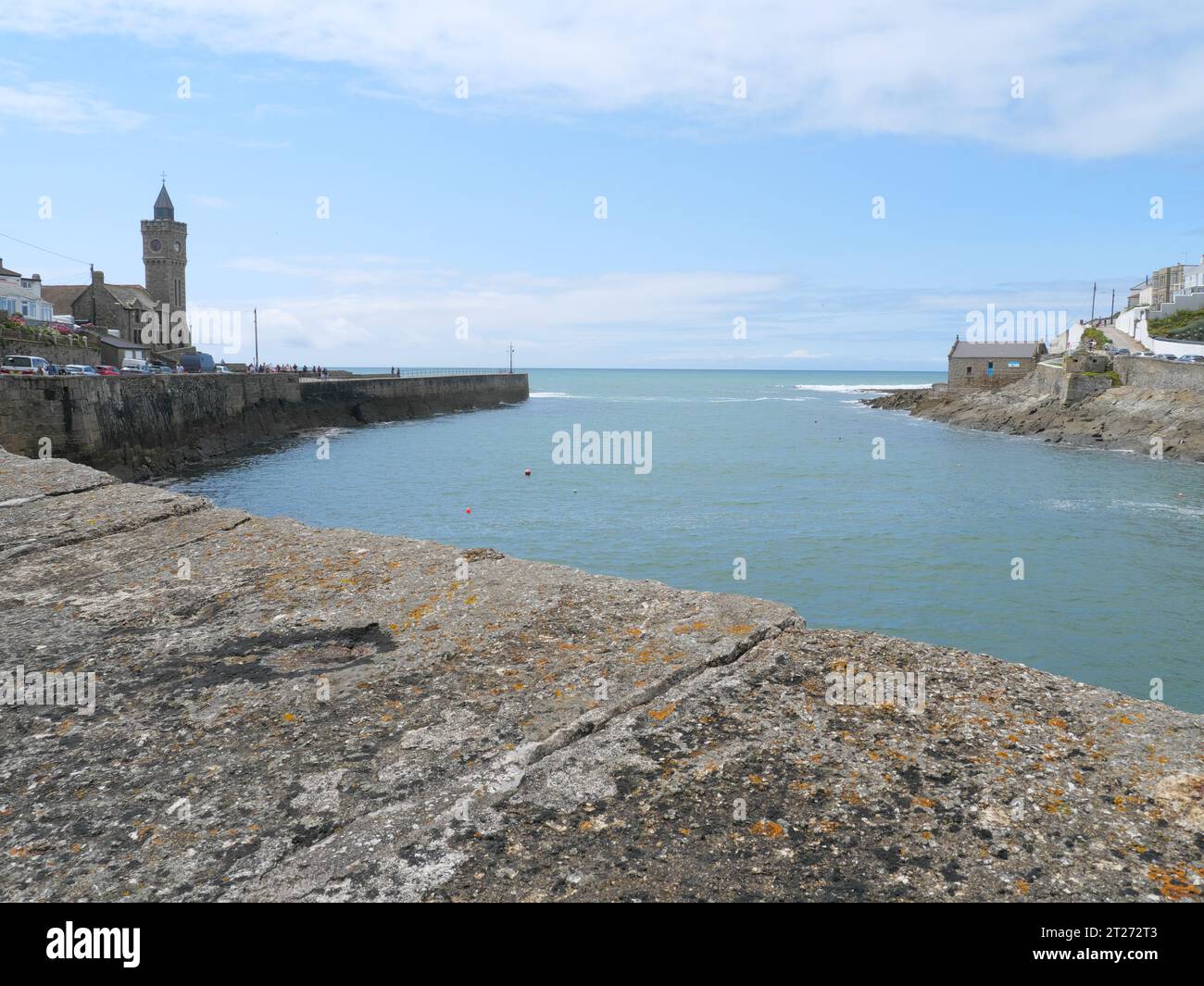 view of harbour, pier and clock tower in Porthleven in Cornwall England ...