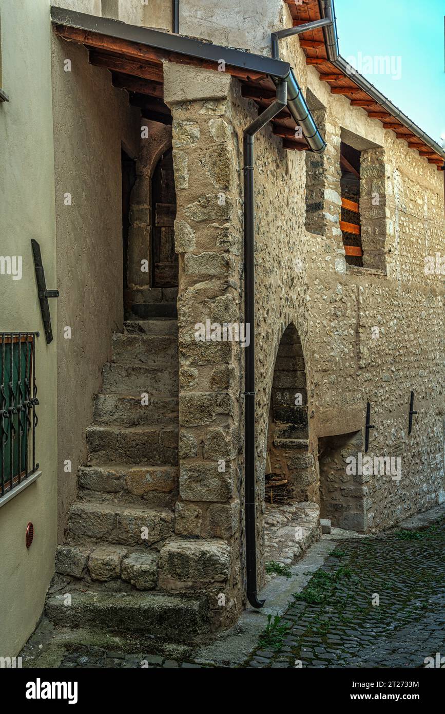 Glimpses of the medieval village with covered steps and stone houses of ...