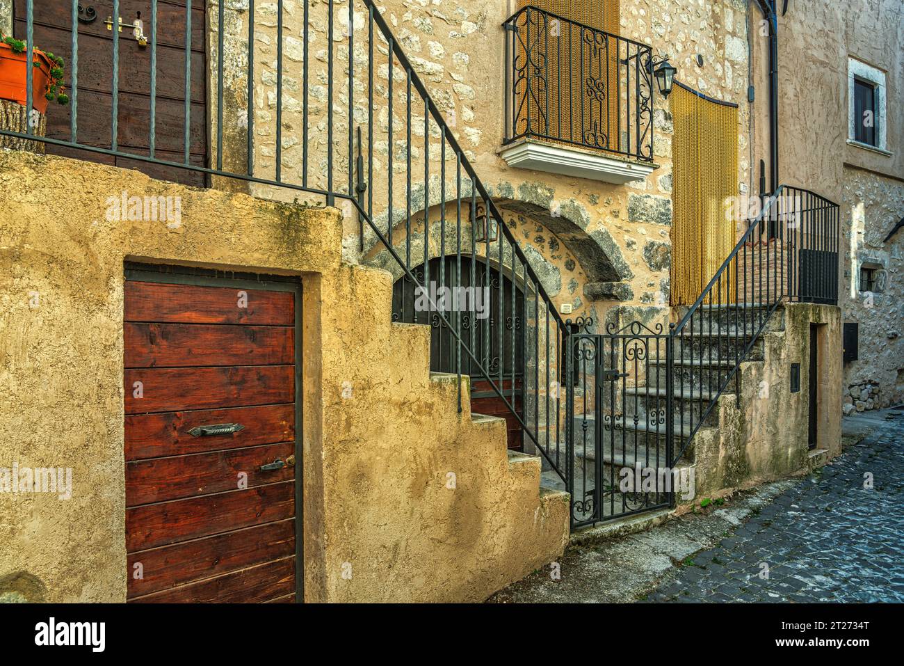 Glimpses of the medieval village with covered steps and stone houses of ...