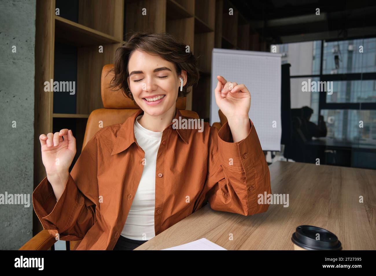 Portrait of young office employee, woman working in conference room ...