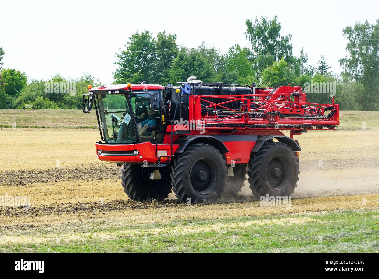 A new modern crop sprayer in the transport condition drives over a ...