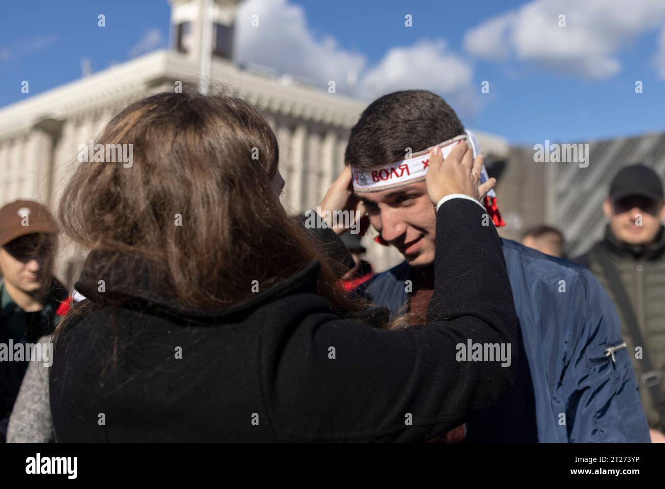 A student leader seen tying a headband on another colleague as a symbol ...