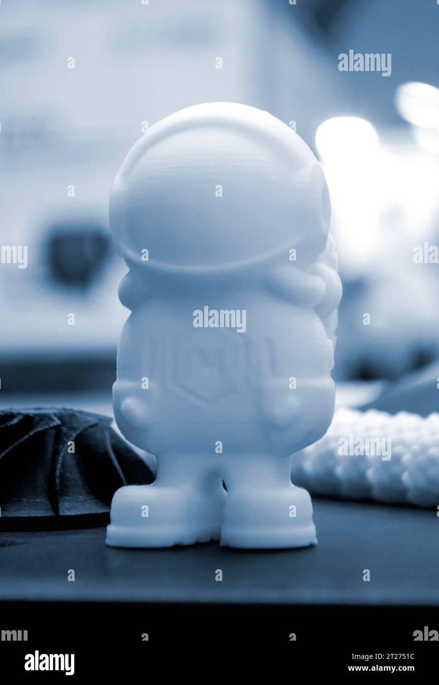 3D printer printing prototype of toy from molten plastic. Process of ...