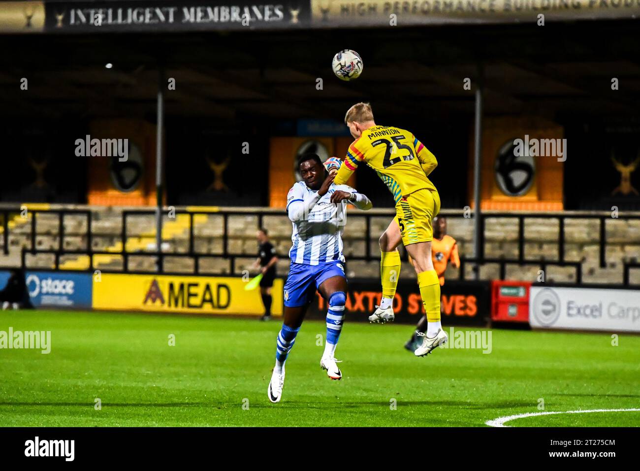 Goalkeeper Will Mannion (25 Cambridge United) heads ball challenged by ...