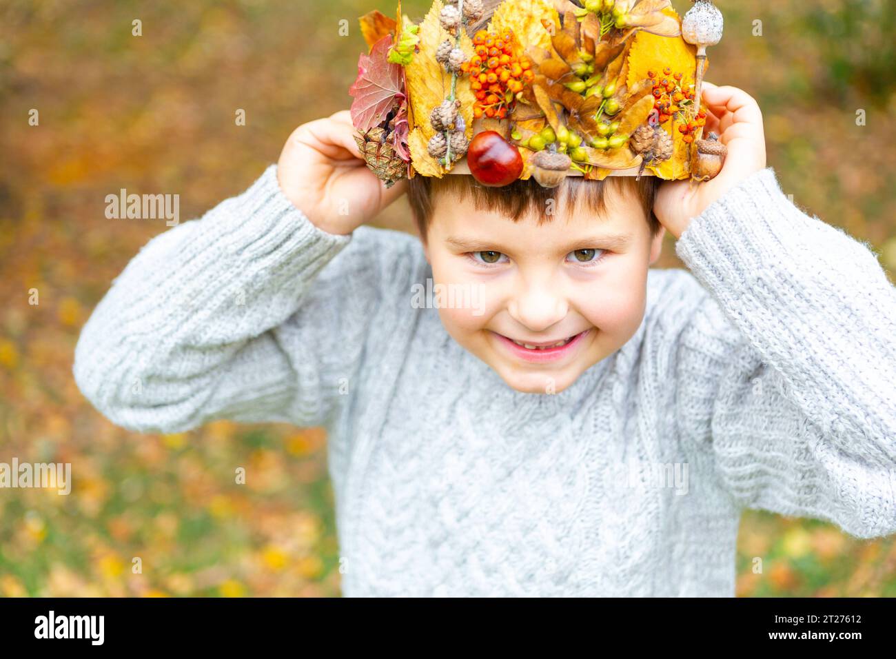 7 October 2023: Little boy is happy with self-made crown made of ...