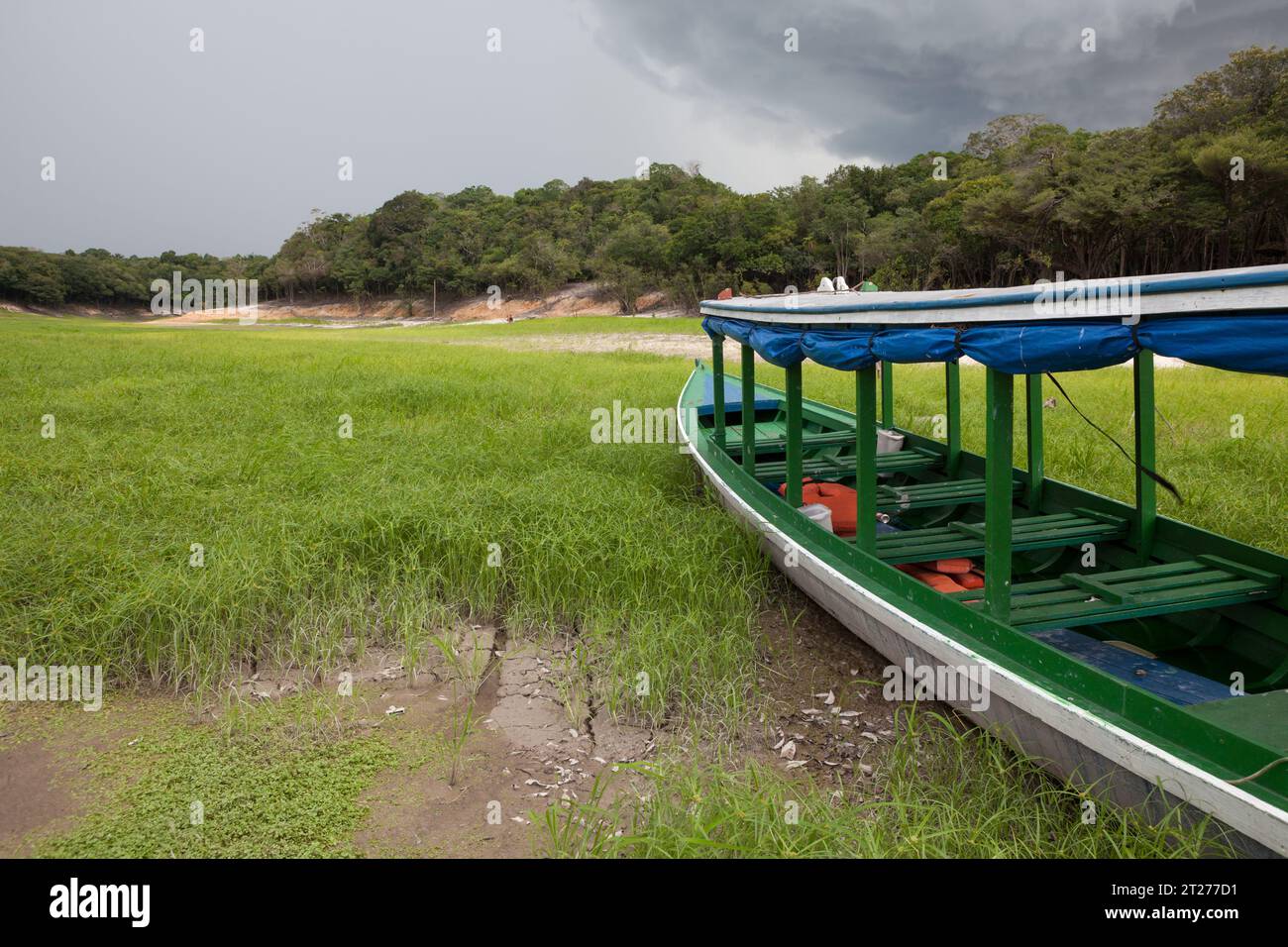 Boat stranded on dry river in extreme drought in the Amazon Rainforest ...