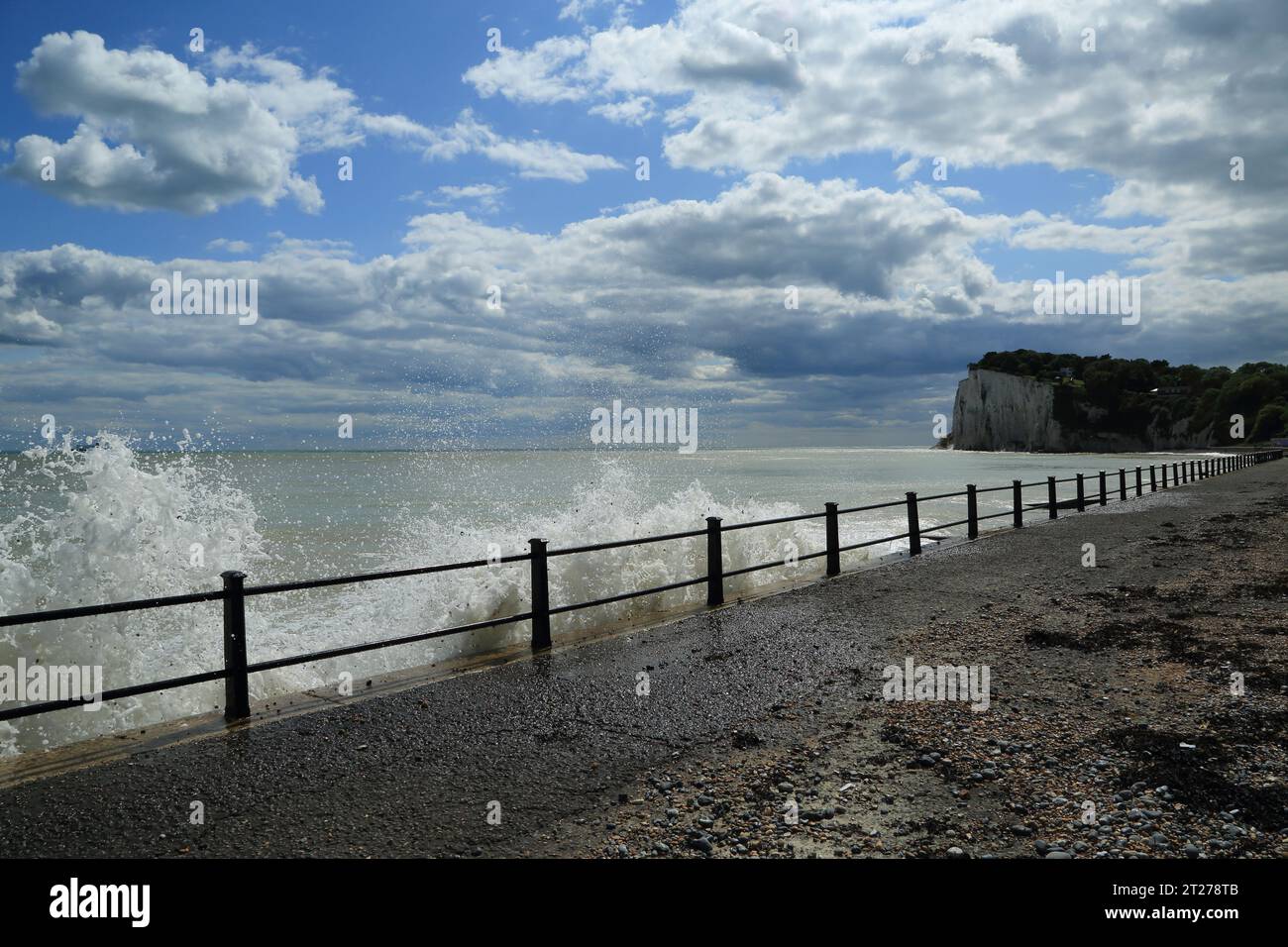 View of white cliffs towards Dover and sea spray from beachside ...