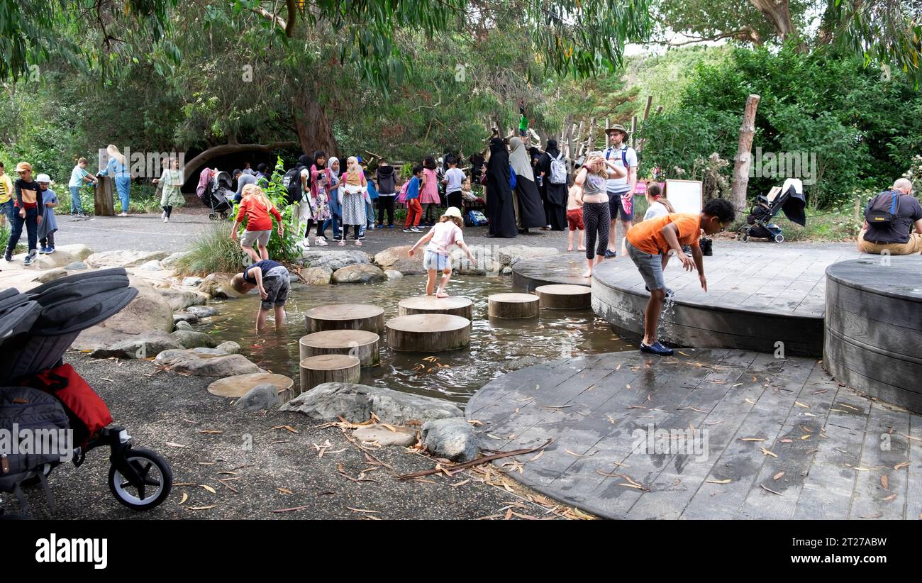 People visitors kids families playing in the children 's garden at Royal Botanic Gardens Kew in ...
